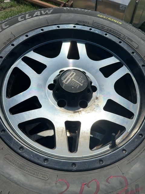 Four tires on black iron aluminum rims ( 2012 Yukon )