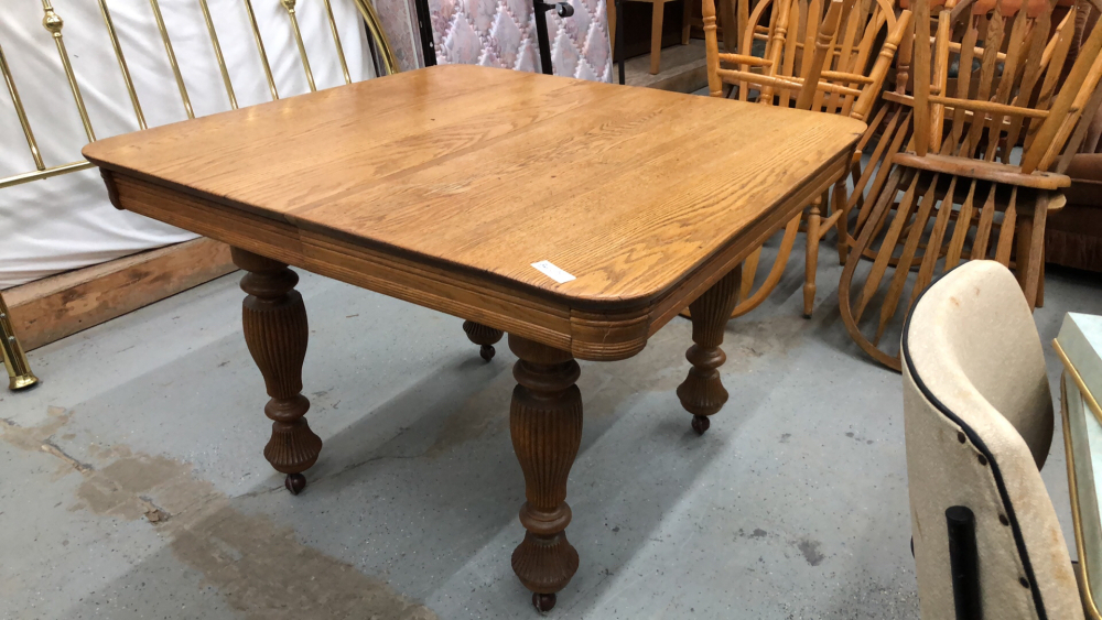 ANTIQUE WOOD DINING TABLE ON CASTORS
