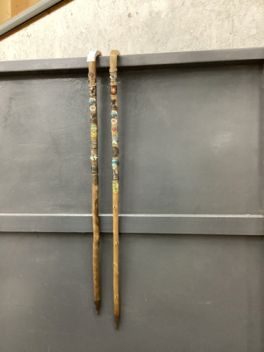 (2) WALKING STICKS W/ DIFFERENT COUNTRY SOUVENIR TAGS ATTACHED